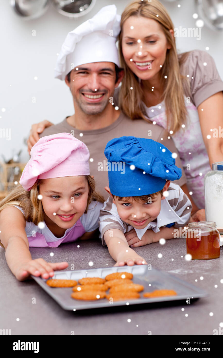 Family eating cookies after baking Stock Photo - Alamy