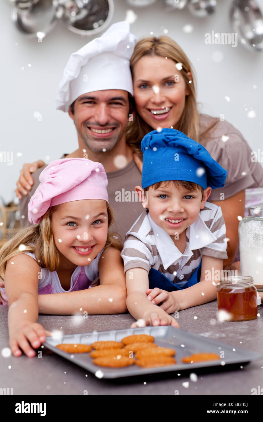Happy children and parents eating biscuits Stock Photo - Alamy