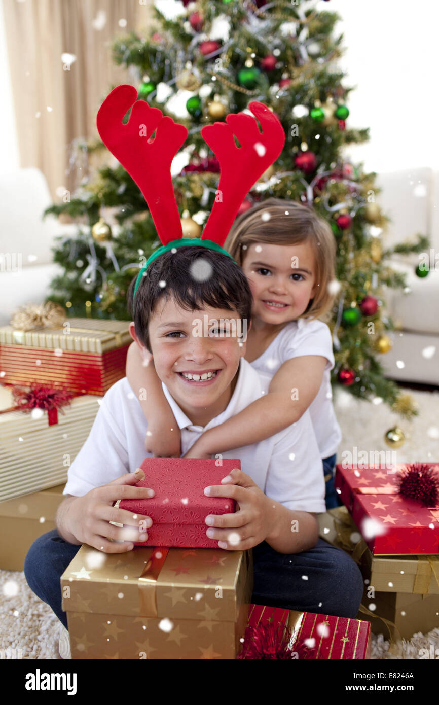Happy brother and sister celebrating christmas Stock Photo - Alamy