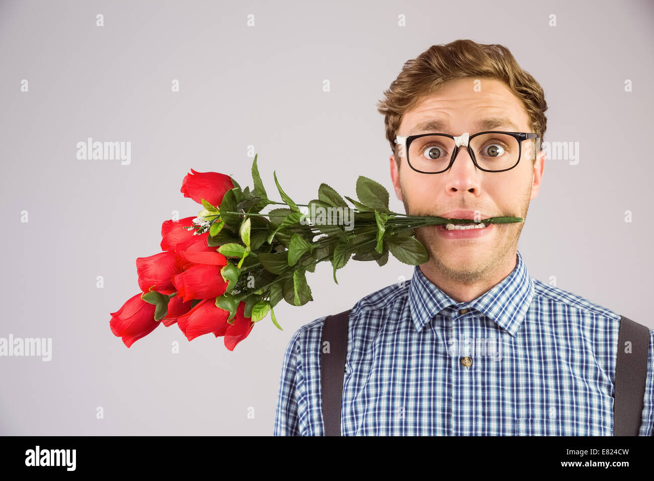 Geeky hipster biting a bunch of roses Stock Photo - Alamy