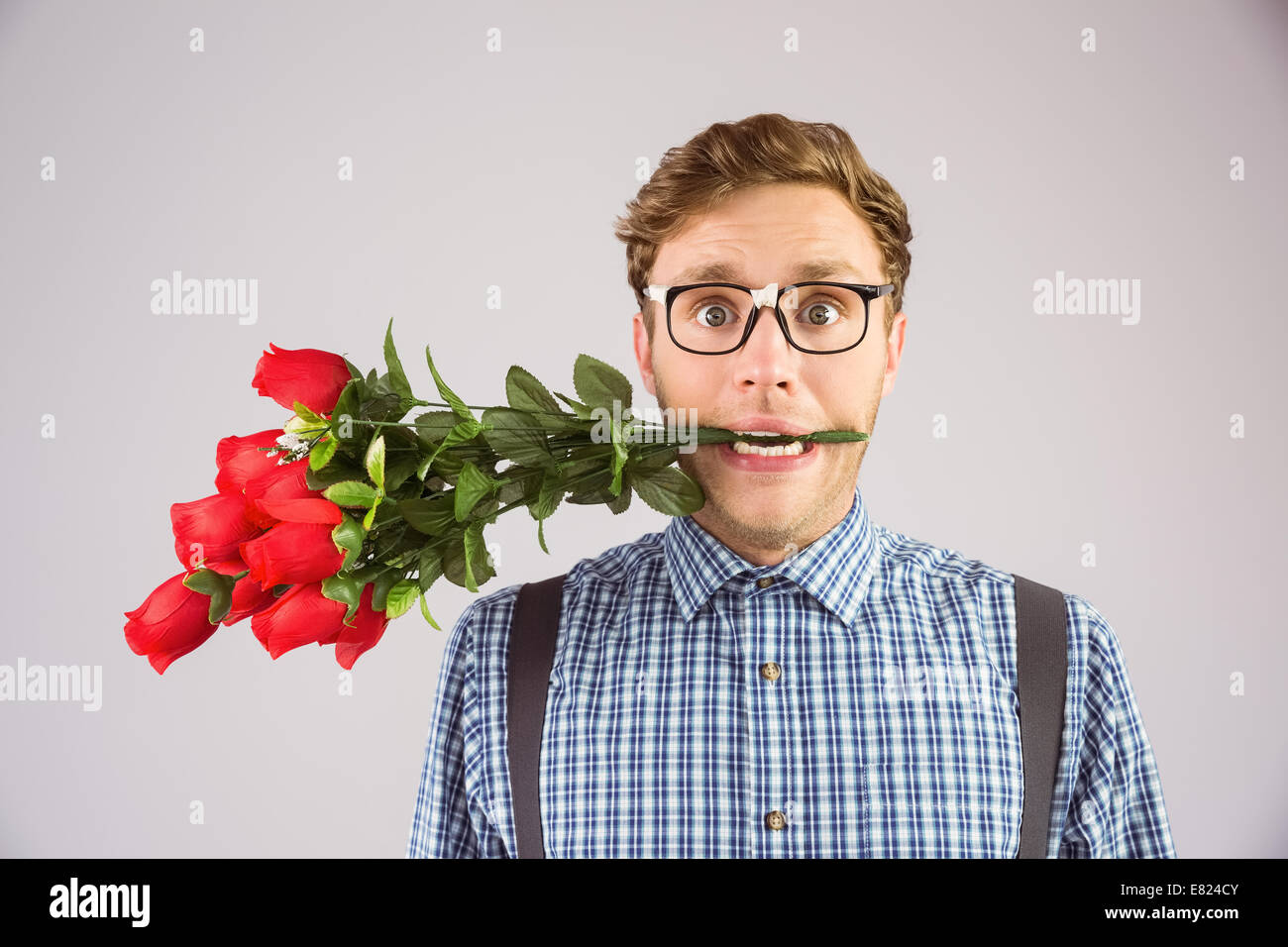 Geeky hipster biting a bunch of roses Stock Photo - Alamy