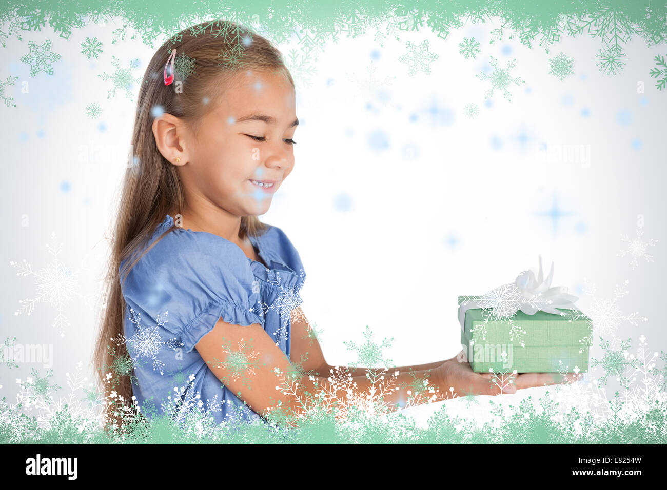 Blonde little girl giving a present Stock Photo - Alamy