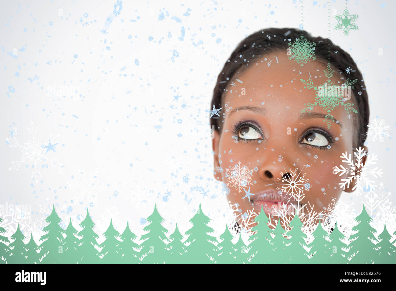 Close up of womans face looking upwards diagonally on white background ...