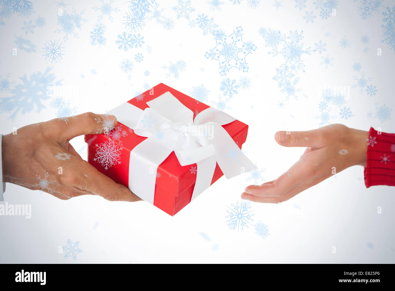 Couple passing a wrapped gift Stock Photo - Alamy