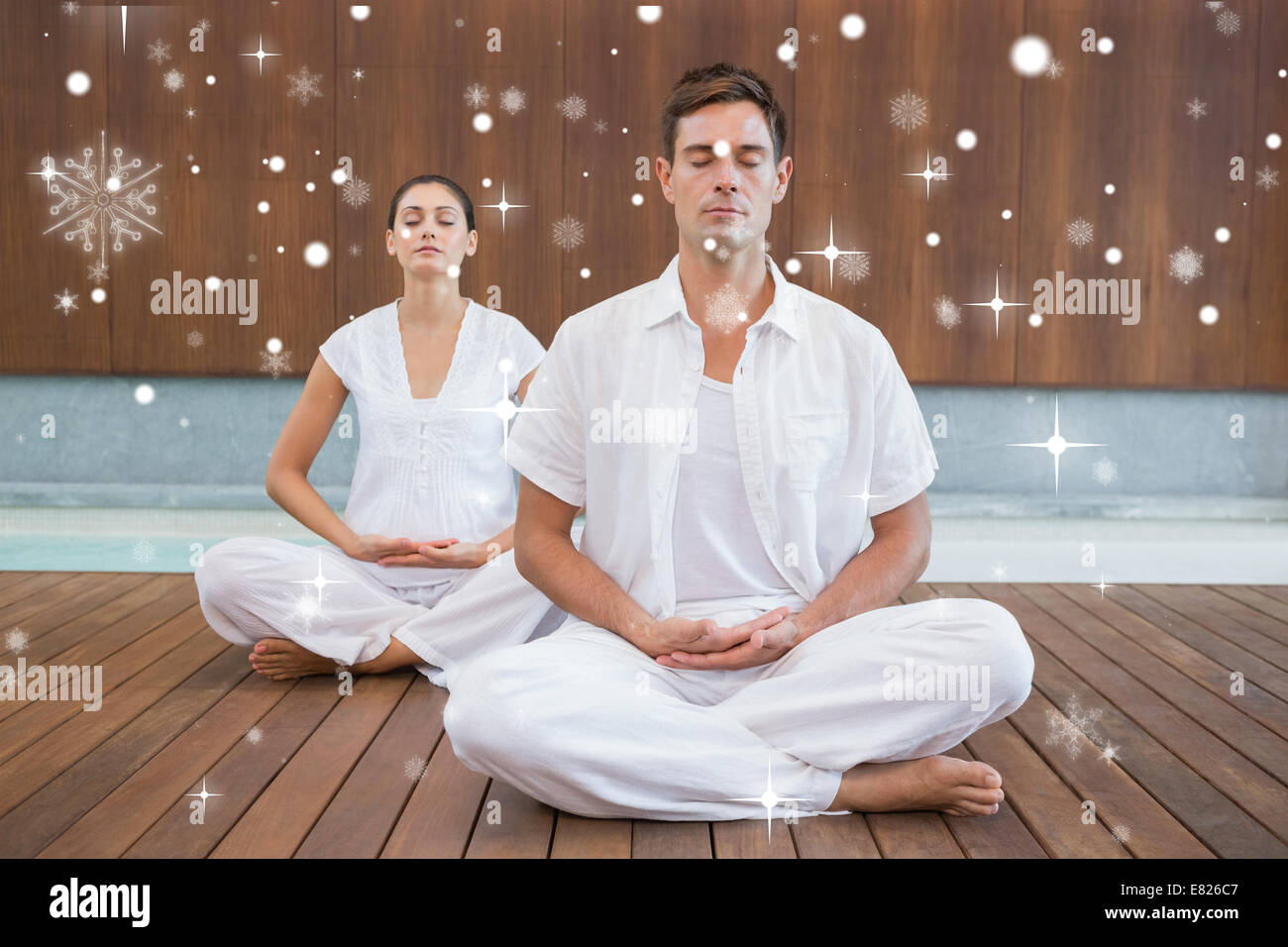 Peaceful couple in white sitting in lotus pose together Stock Photo - Alamy