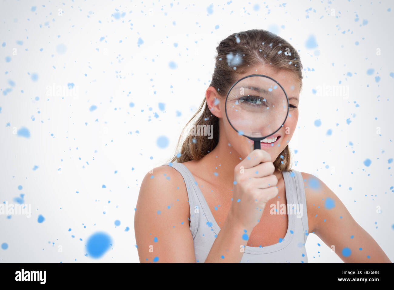 Woman looking through a magnifying glass Stock Photo - Alamy