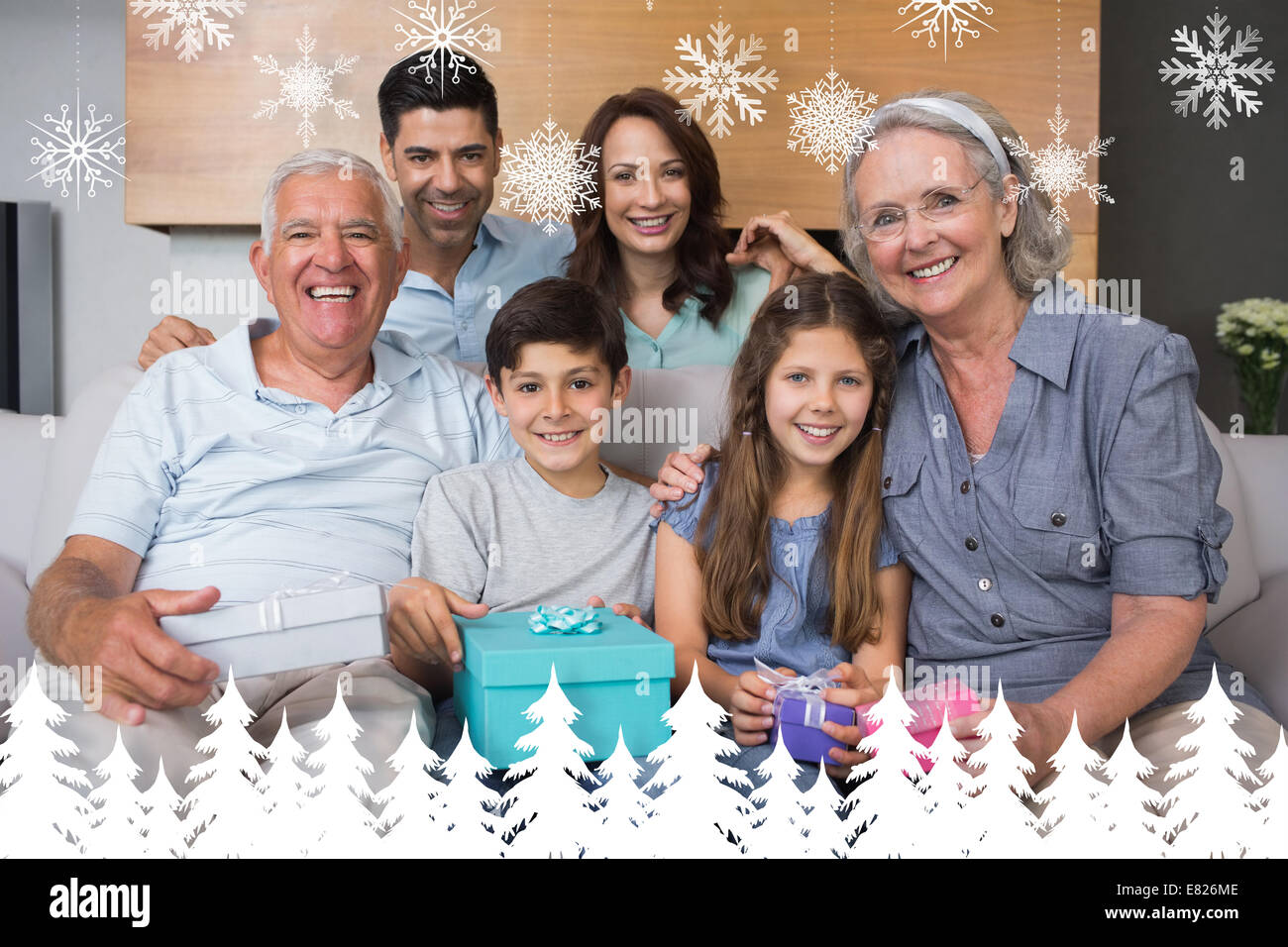 Composite image of extended family on sofa with gift boxes in living ...