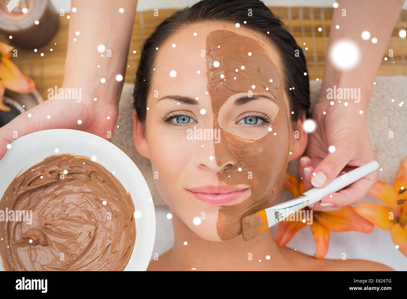 Peaceful brunette getting a mud facial applied Stock Photo - Alamy