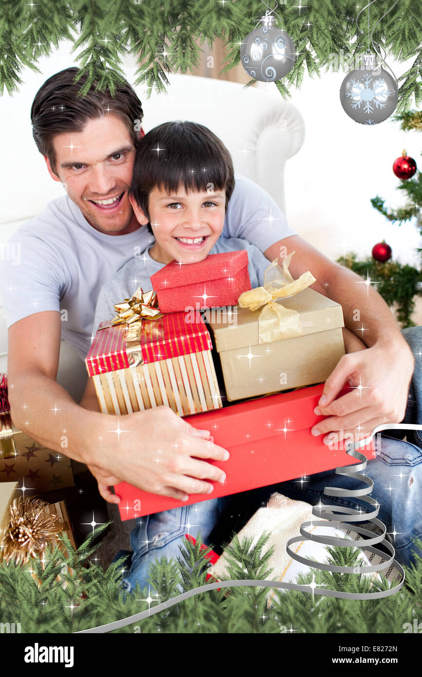 Happy father and son holding christmas presents Stock Photo - Alamy