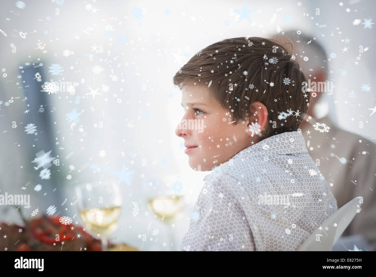 Composite image of side view of a little boy at table Stock Photo - Alamy