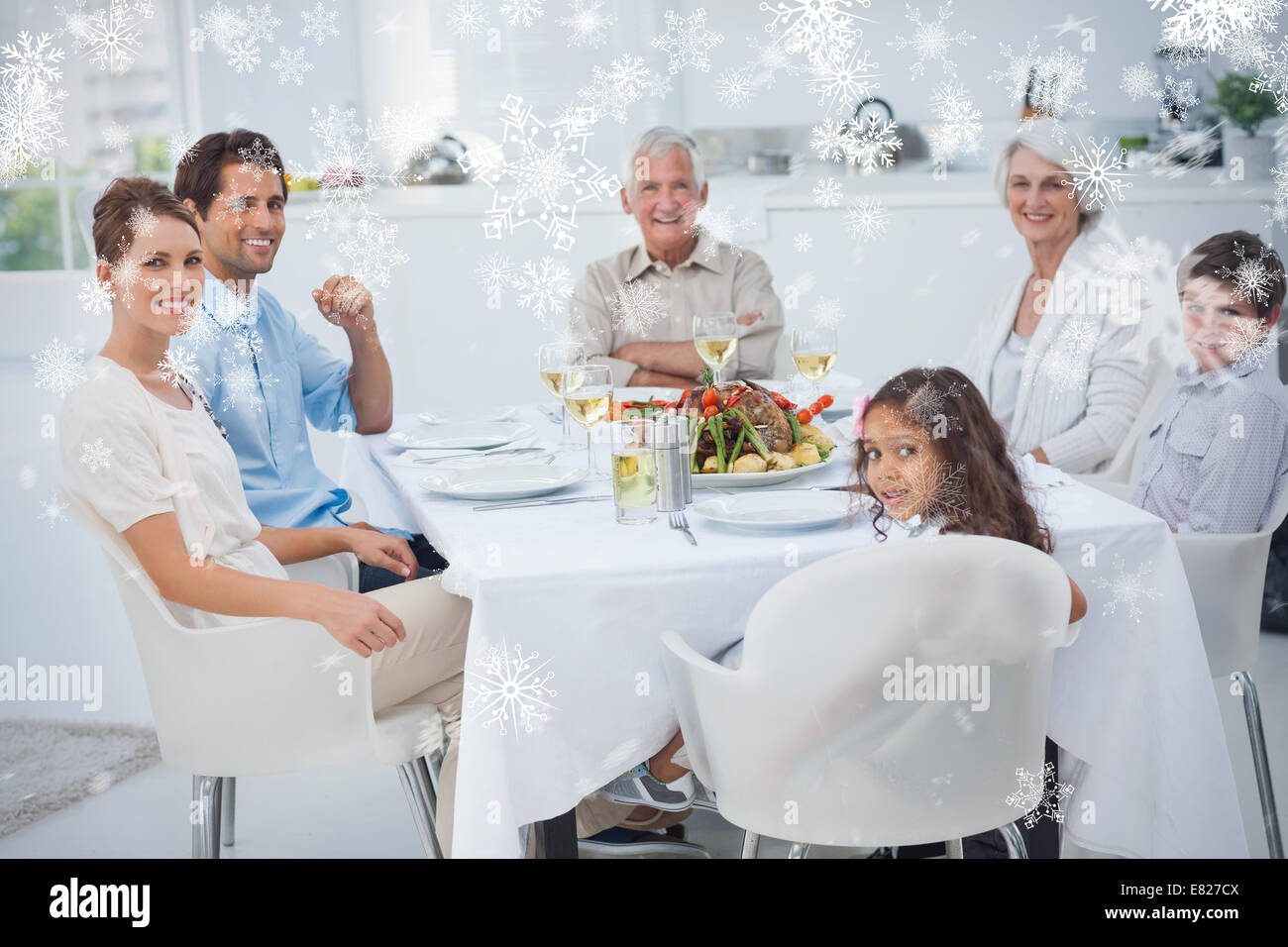 Composite image of family smiling at the dinner table Stock Photo - Alamy