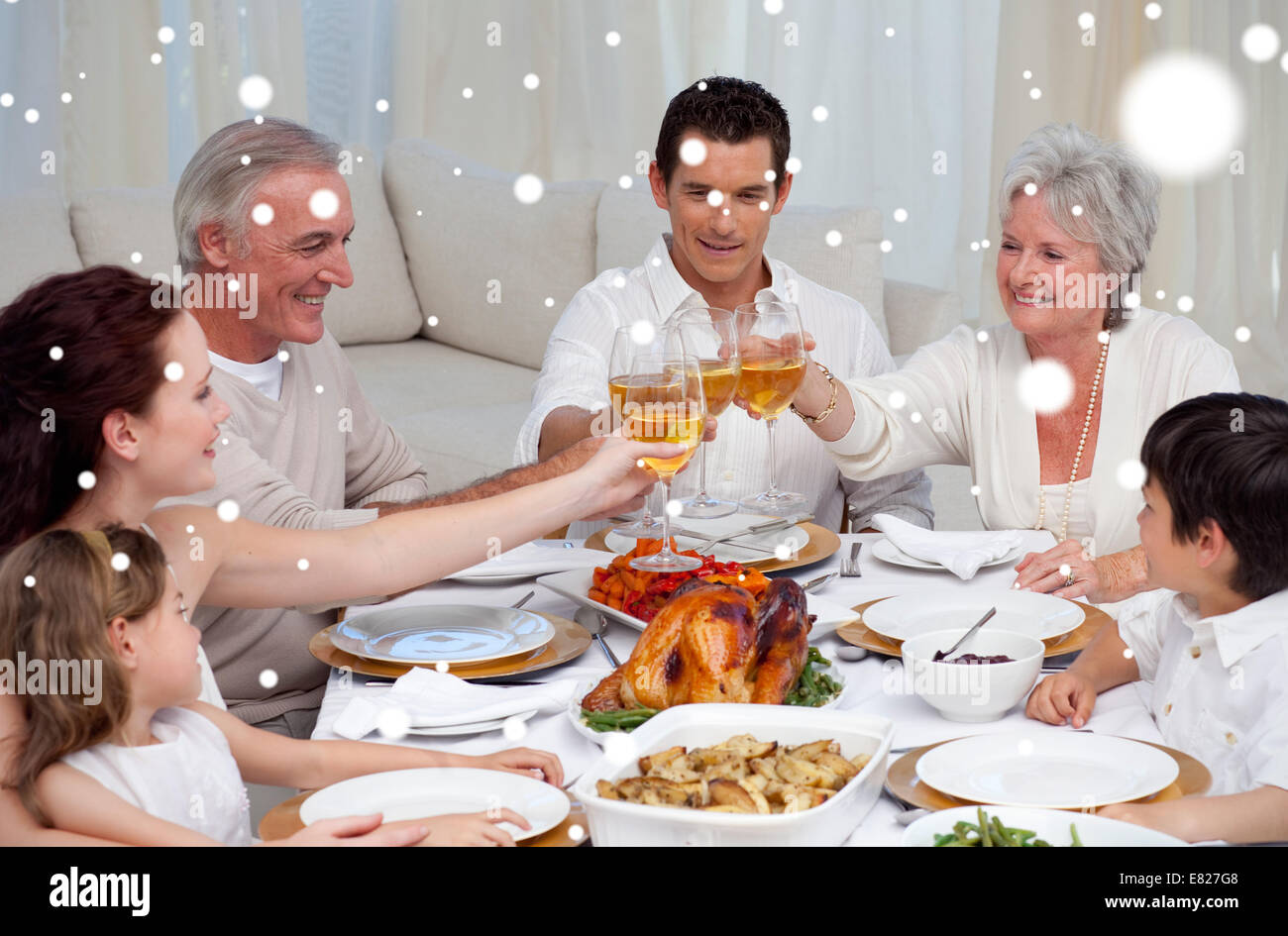 Composite image of family toasting with wine in a dinner Stock Photo ...