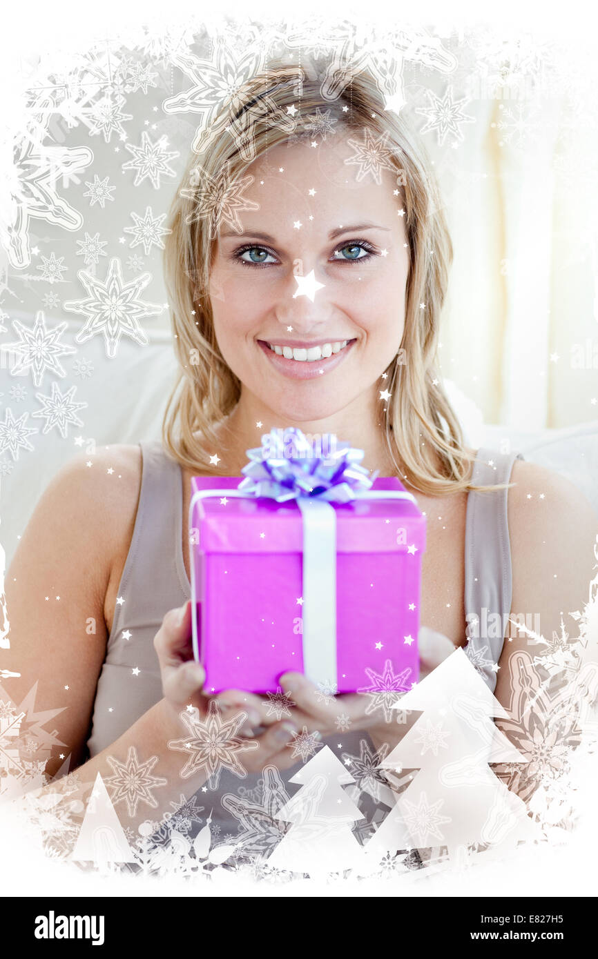 Woman holding a present in a living room Stock Photo - Alamy