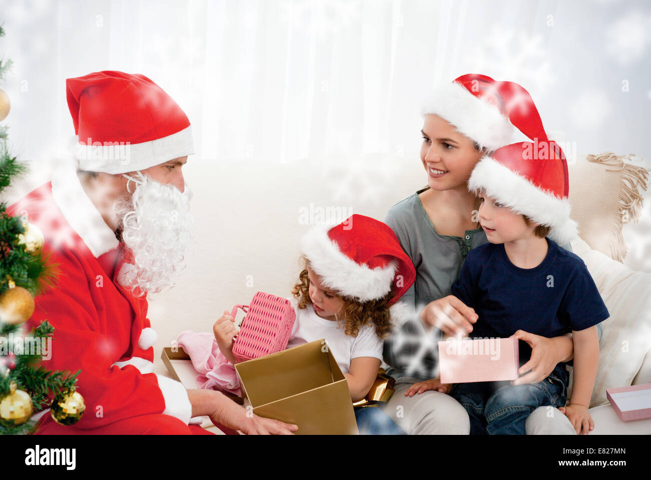 Santa giving presents to his children in the living room Stock Photo ...