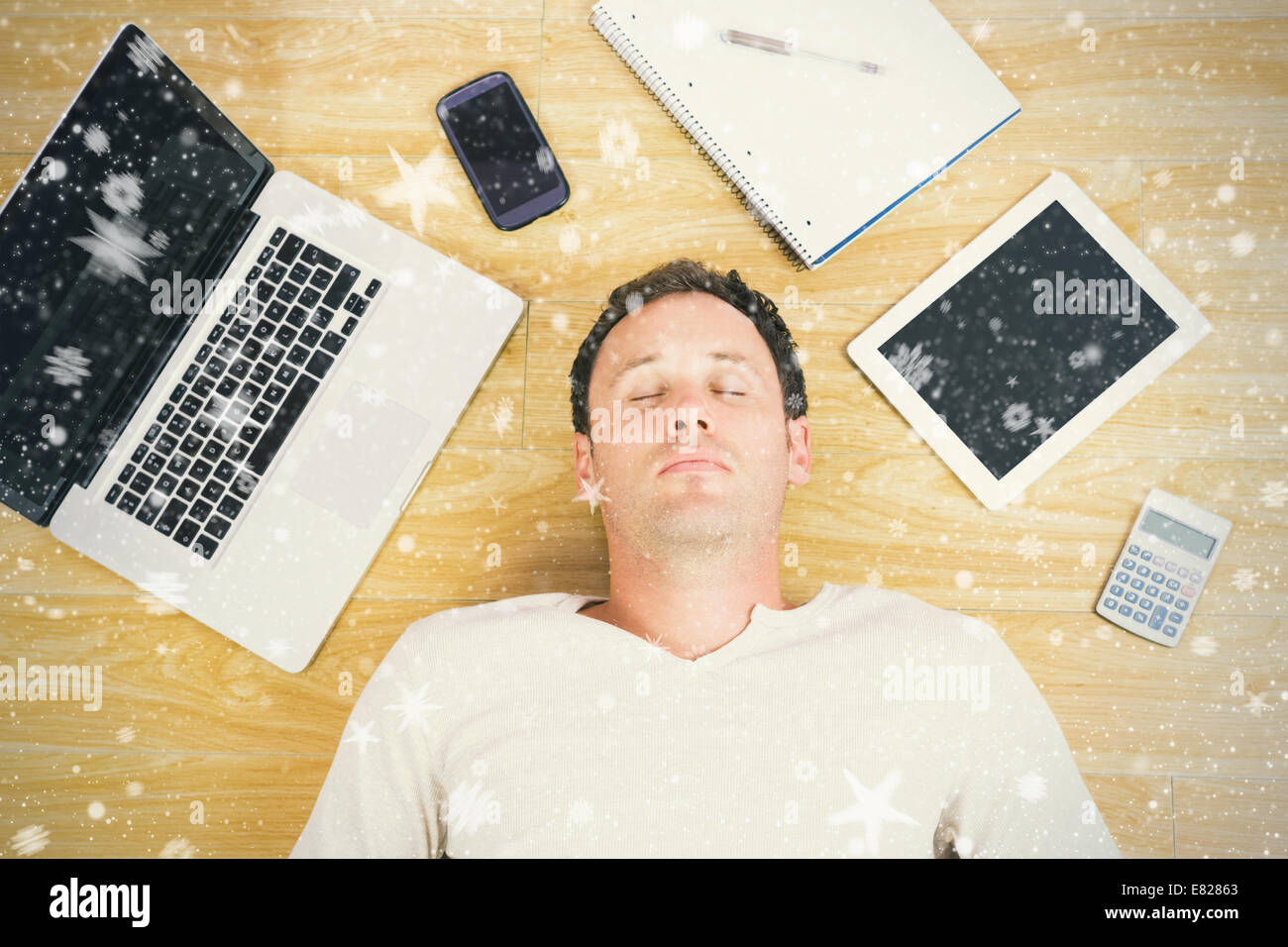 Composite image of casual tired man lying on floor Stock Photo - Alamy