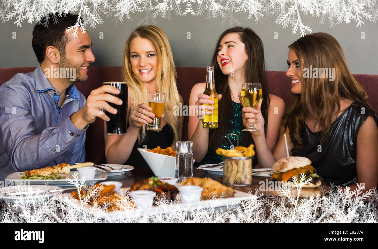 Composite image of friends having dinner together and toasting Stock ...