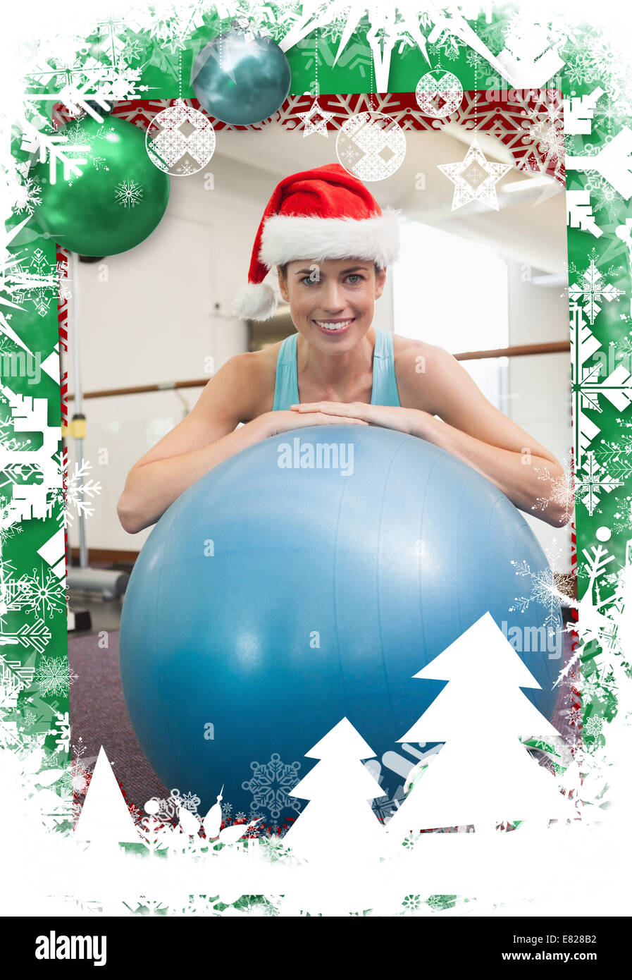 Fit smiling brunette in santa hat leaning on exercise ball Stock Photo ...