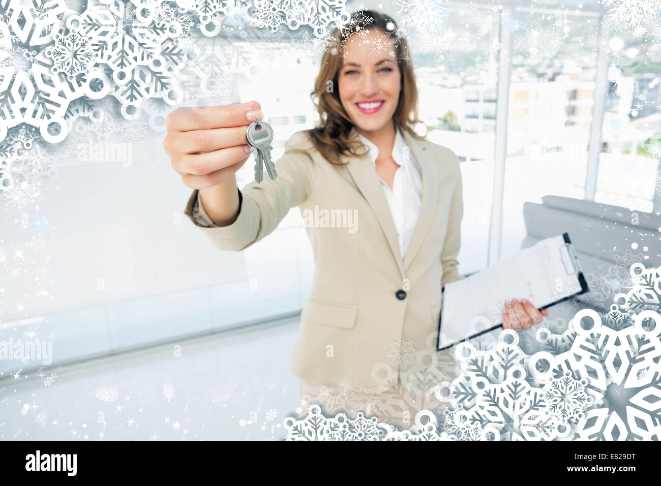 Beautiful happy woman handing over house keys Stock Photo - Alamy