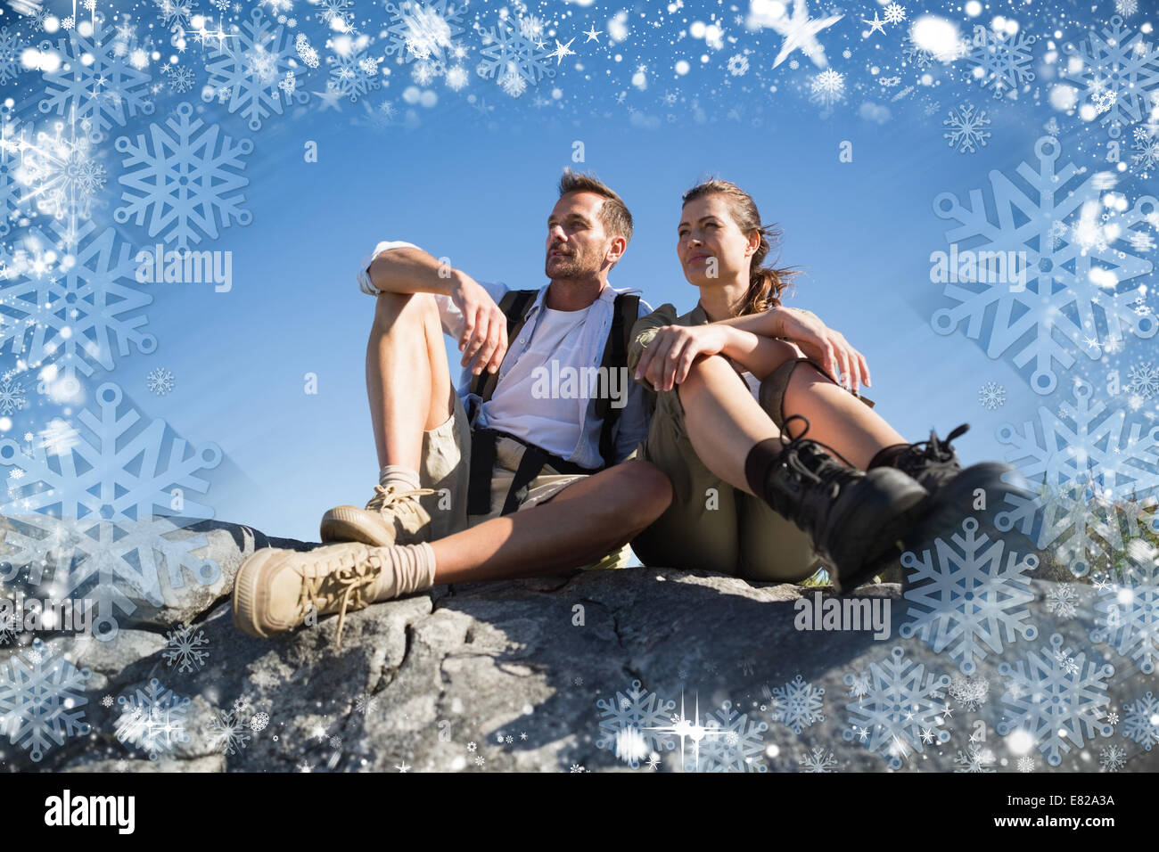 Hiking couple looking out over mountain terrain Stock Photo - Alamy