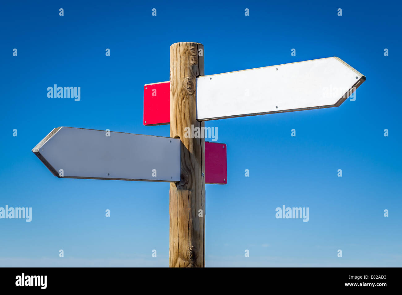 Wooden road sign with walking routes Stock Photo - Alamy