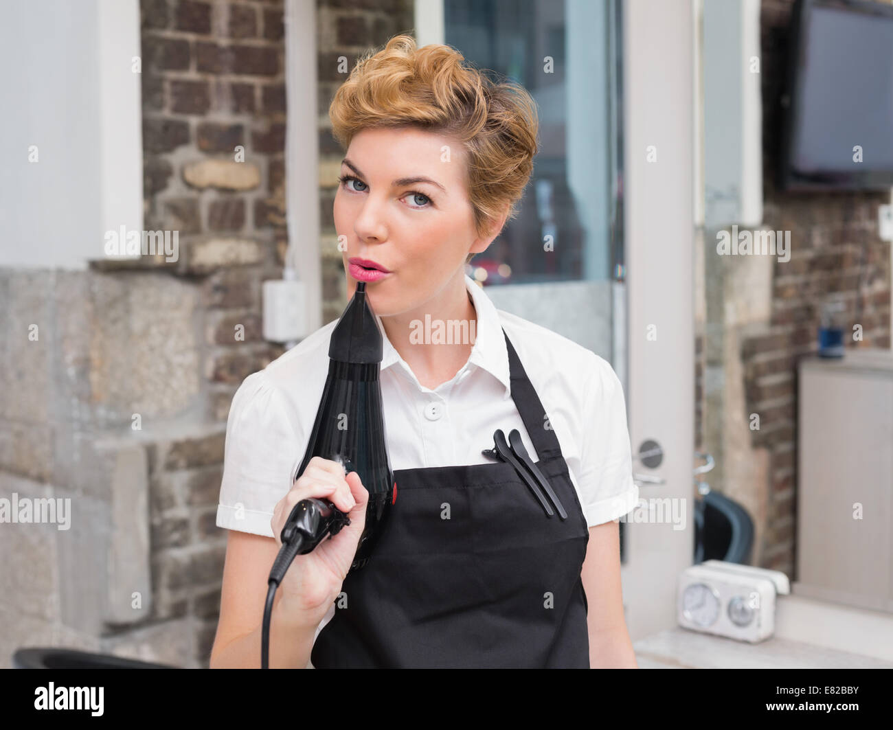 Confident hairdresser smiling at camera Stock Photo - Alamy