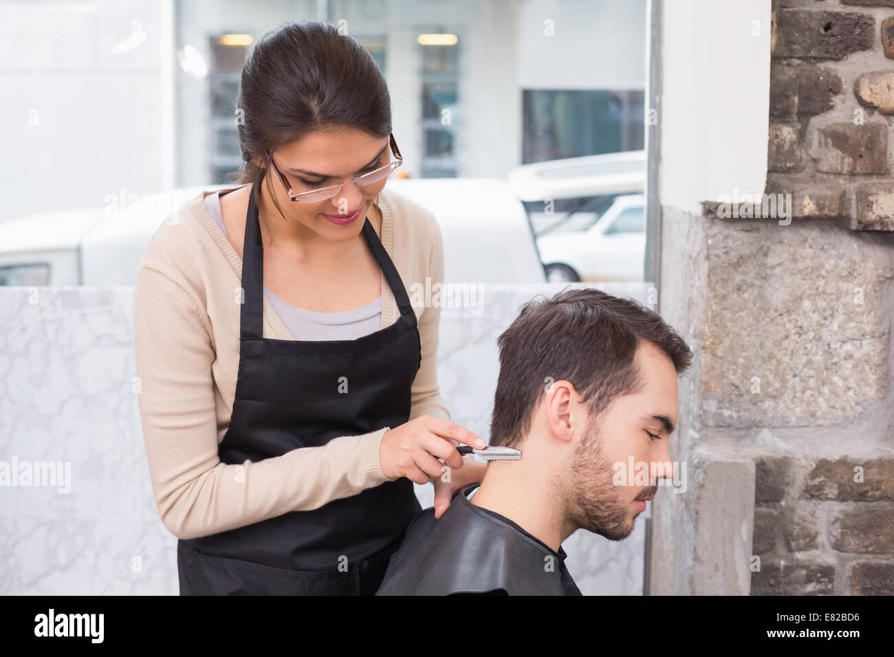 Handsome man getting his hair trimmed Stock Photo - Alamy