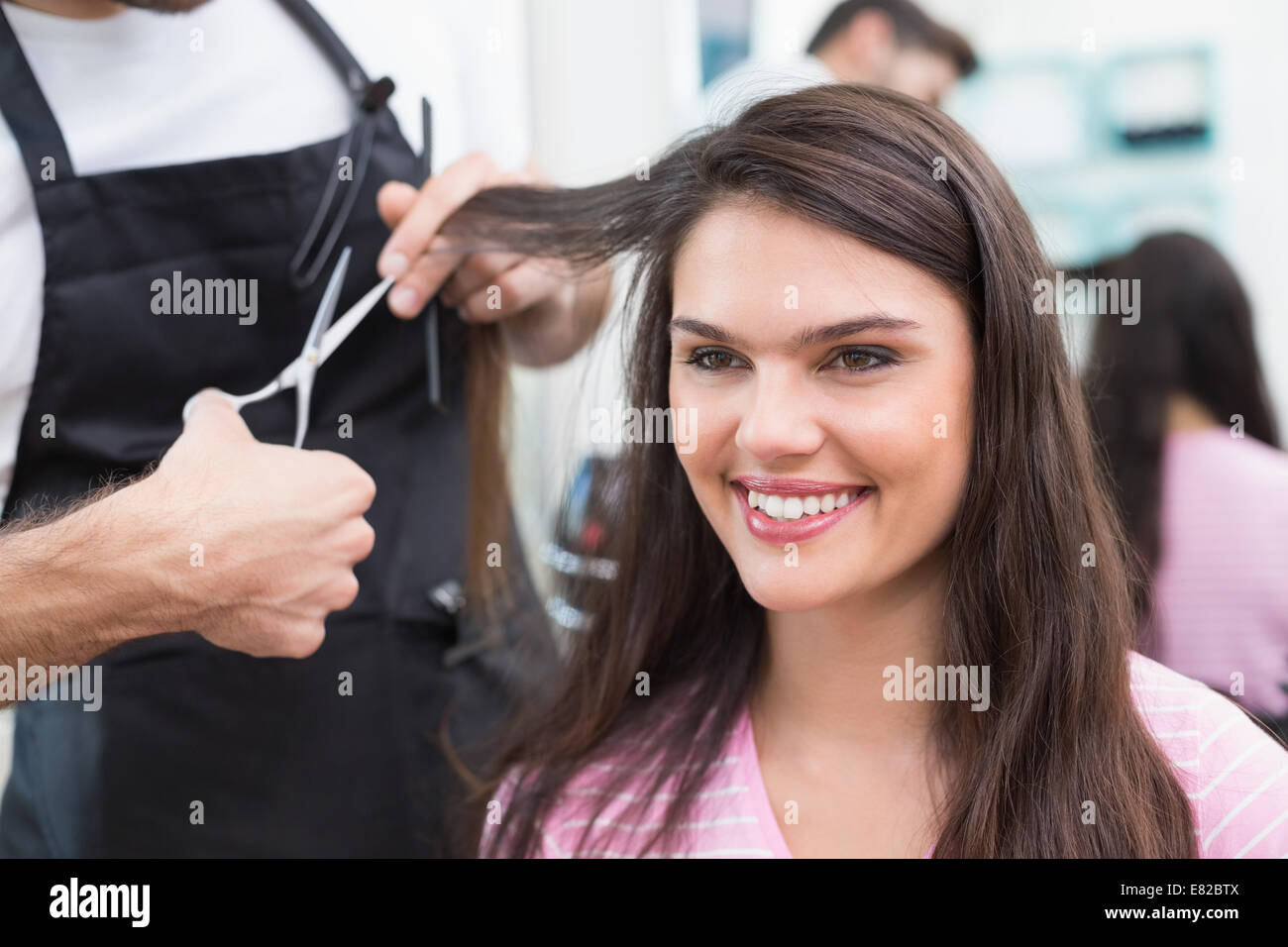 Pretty brunette getting her hair cut Stock Photo - Alamy