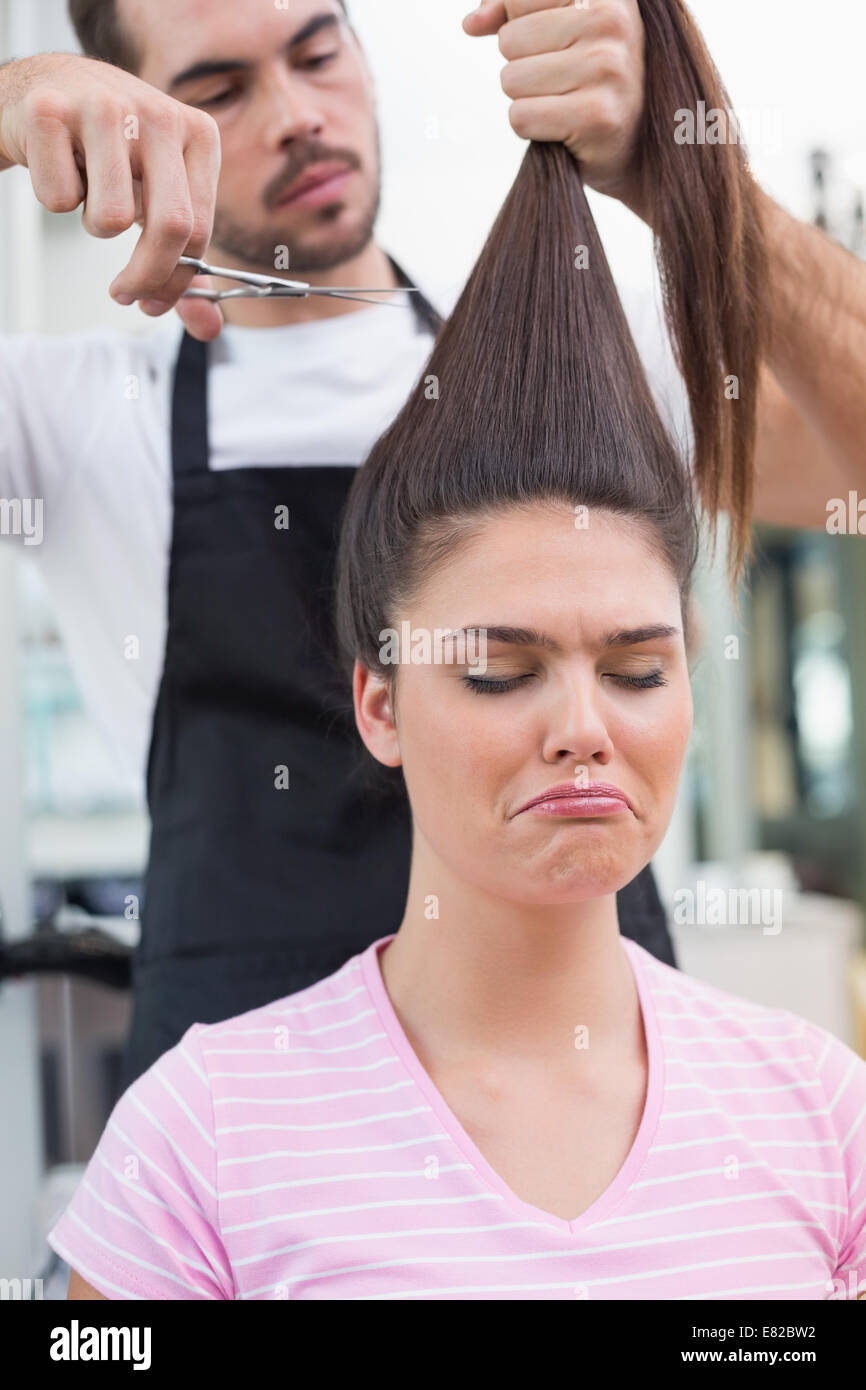 Sad brunette getting her hair cut Stock Photo - Alamy