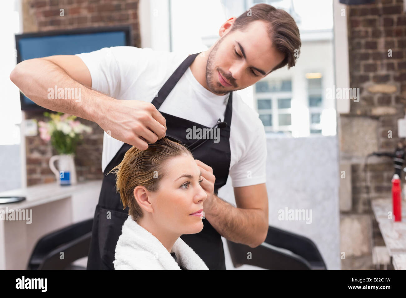 Handsome hair stylist with client Stock Photo - Alamy