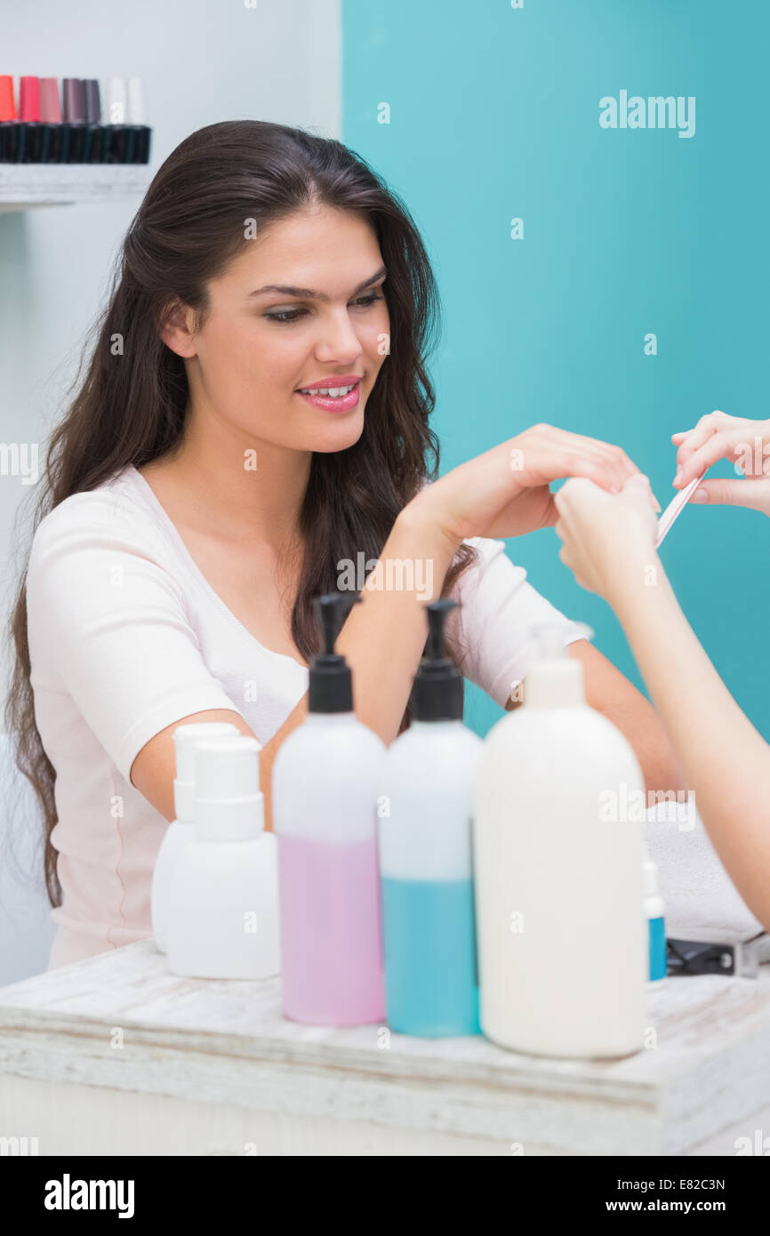 Pretty nail technician giving manicure to customer Stock Photo - Alamy