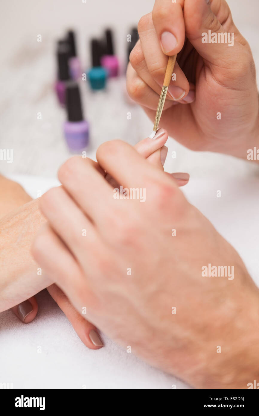 Manicurist cleaning a customers nails Stock Photo - Alamy