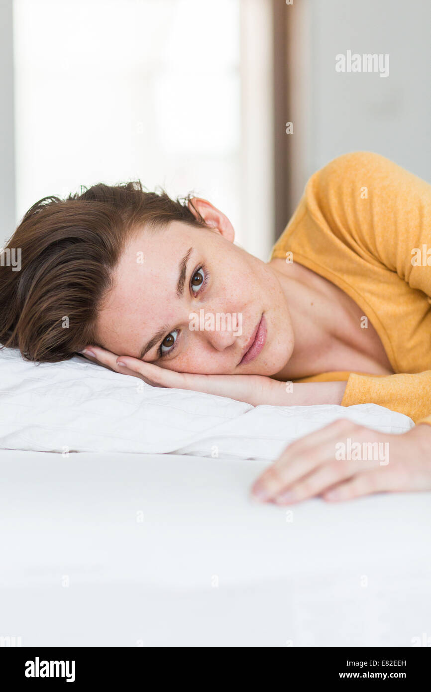 Woman resting bed Stock Photo - Alamy