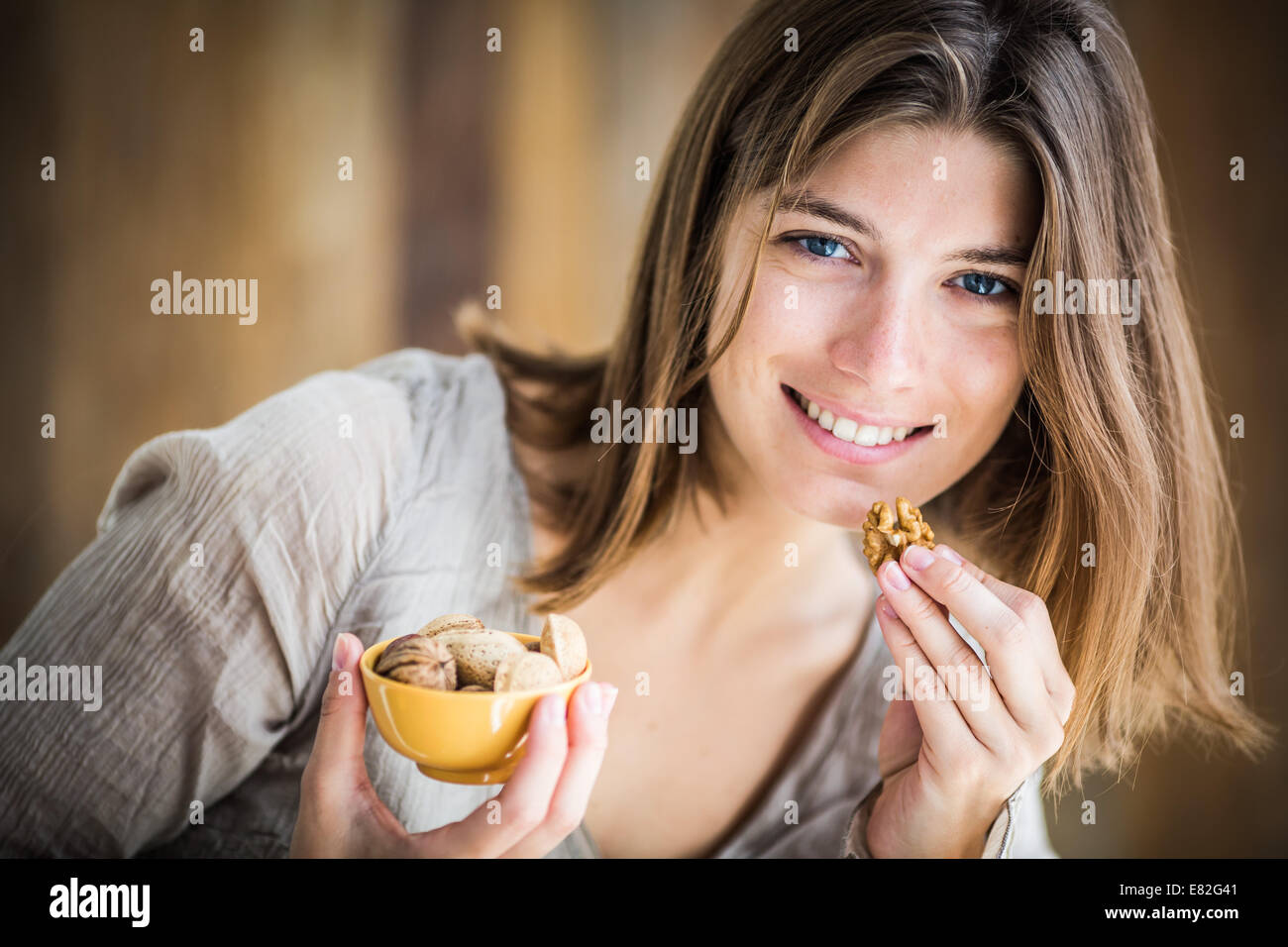 Woman eating several nuts Stock Photo - Alamy