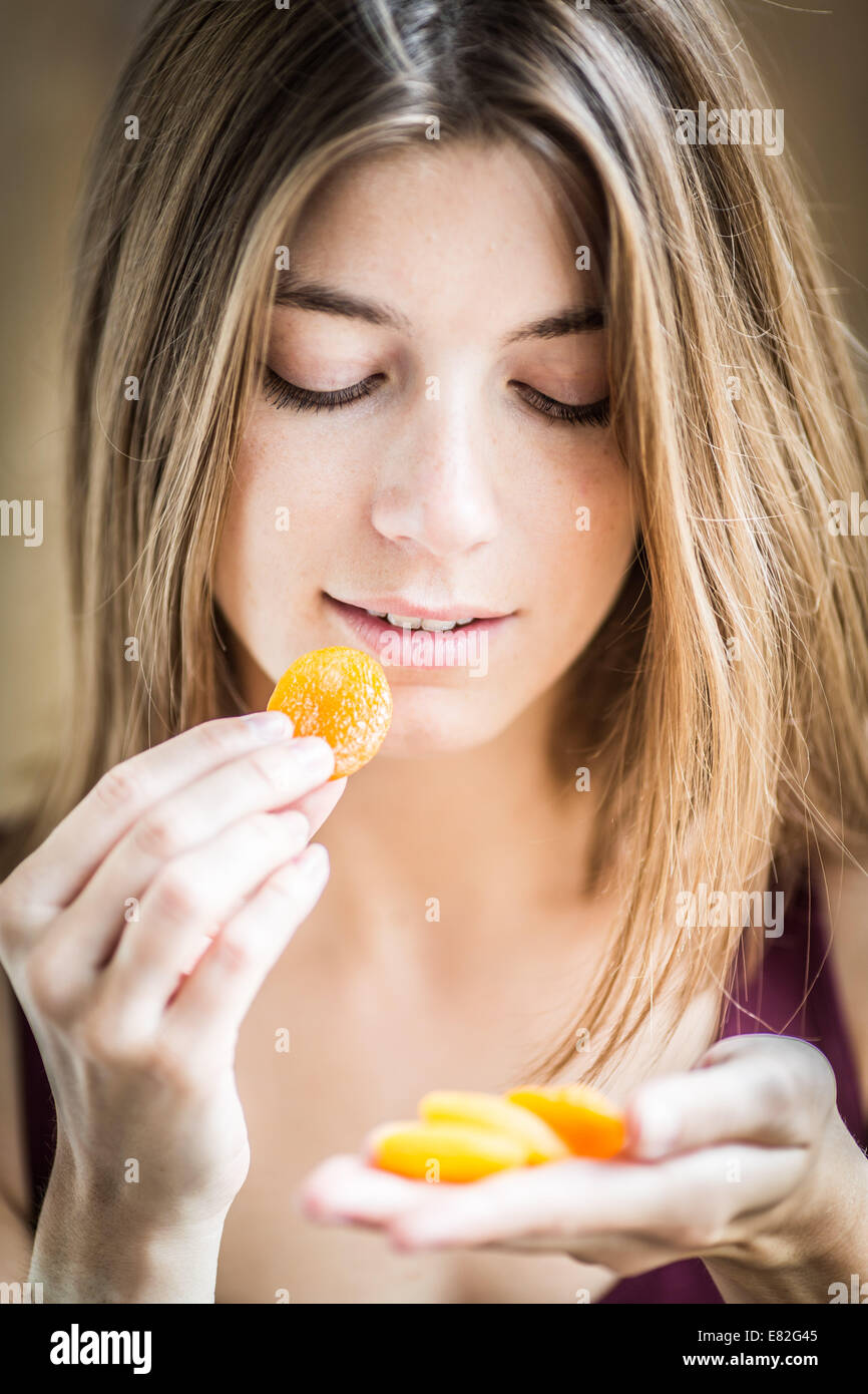 Woman eating dry apricot Stock Photo - Alamy