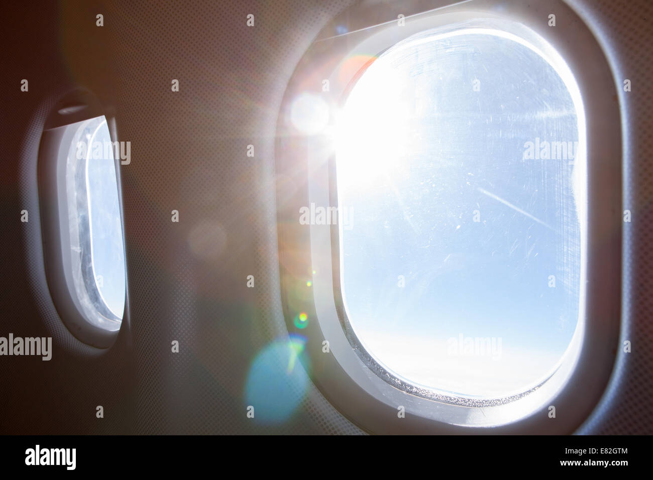 Sunlight through airplane window Stock Photo - Alamy