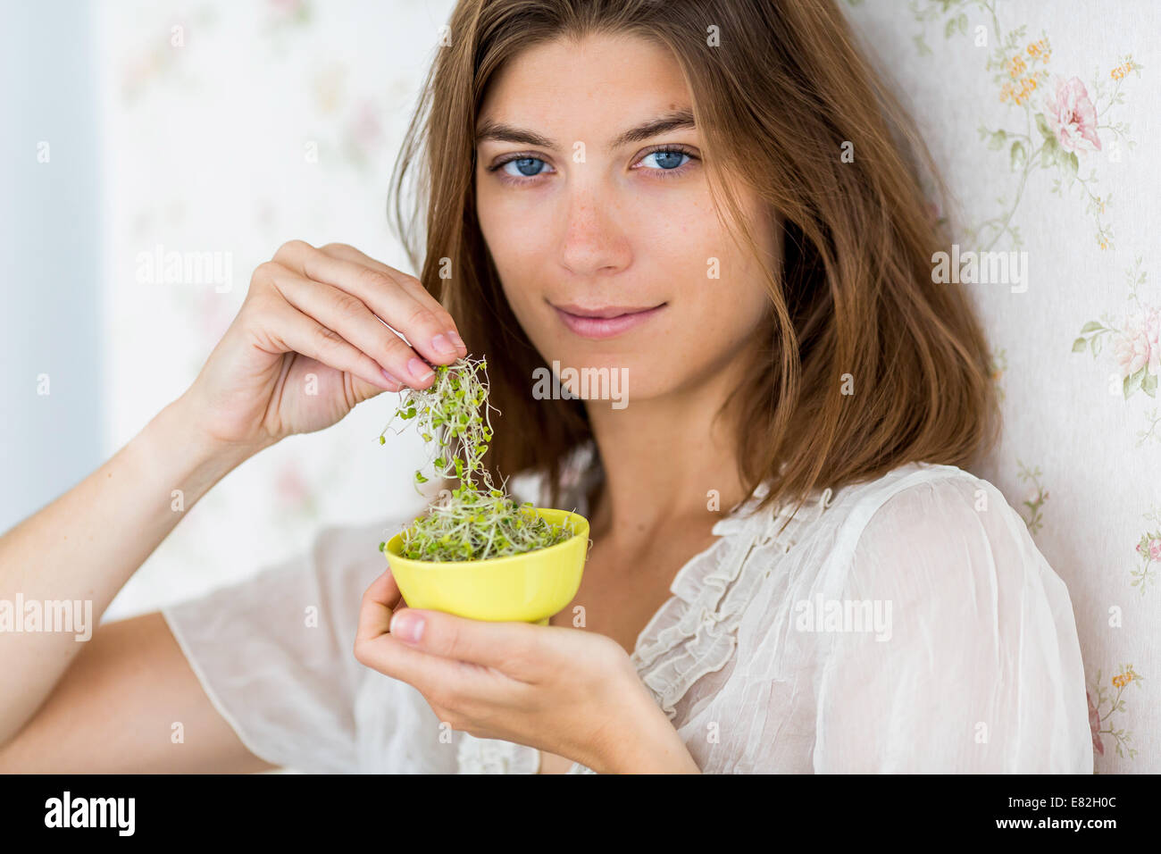 Woman eating sprouts Stock Photo - Alamy