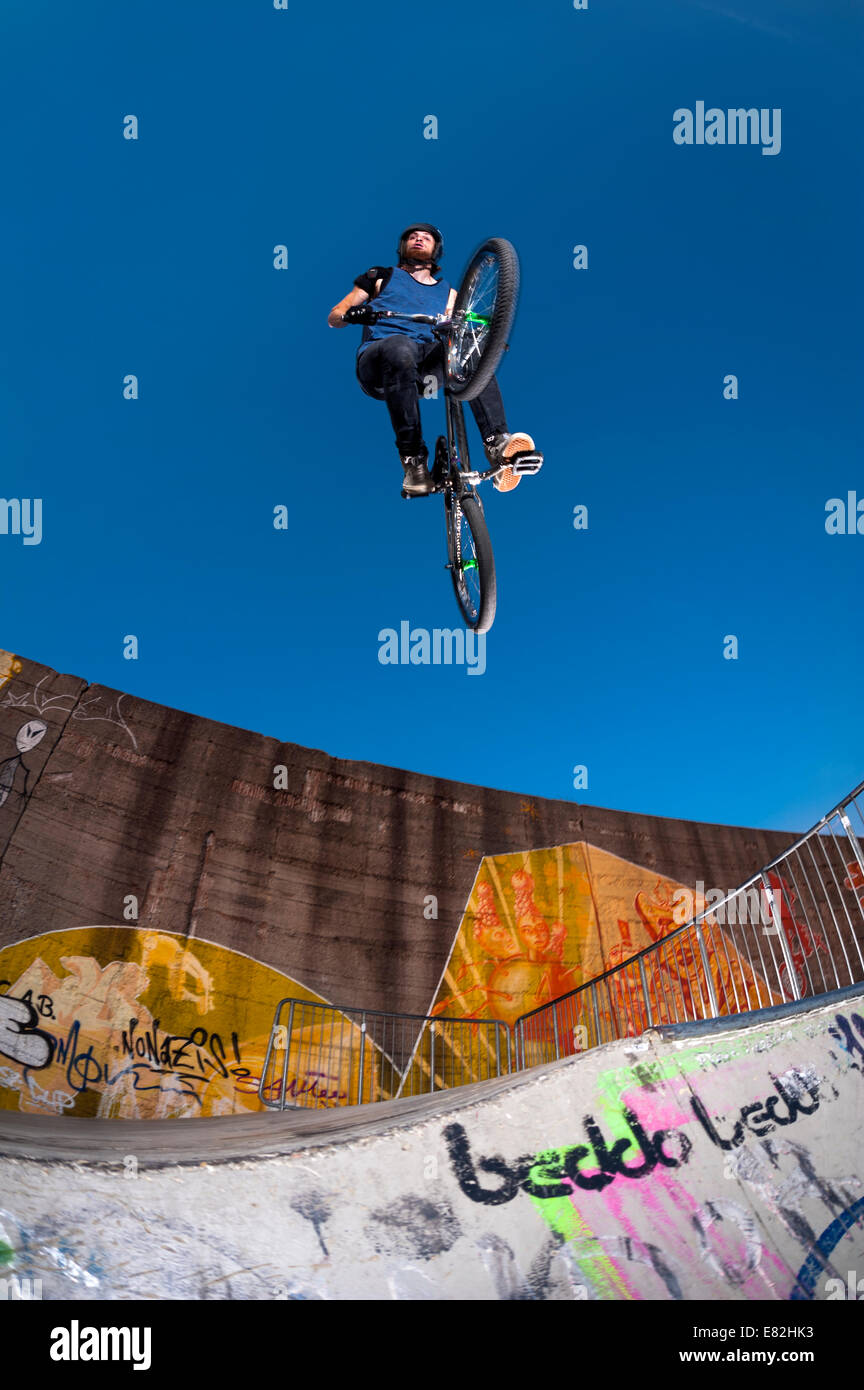 Germany, Young man performing stunt on BMX bike Stock Photo - Alamy