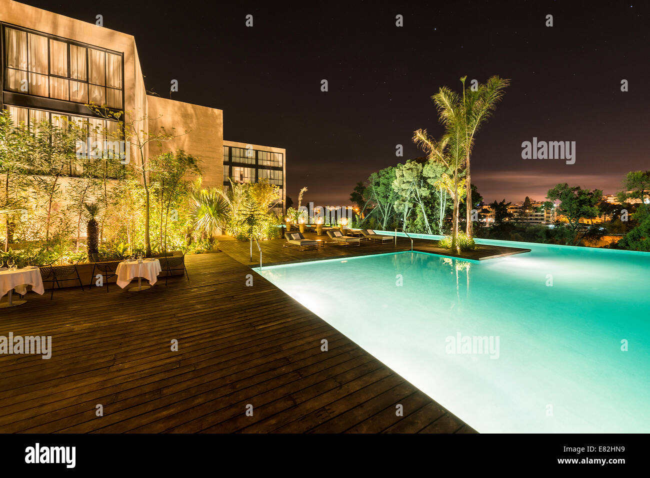 Morocco, Fes, view to lighted swimming pool at roof terrace of a hotel ...