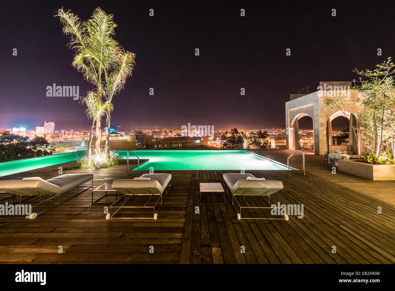 Morocco, Fes, view to lighted swimming pool at roof terrace of a hotel ...