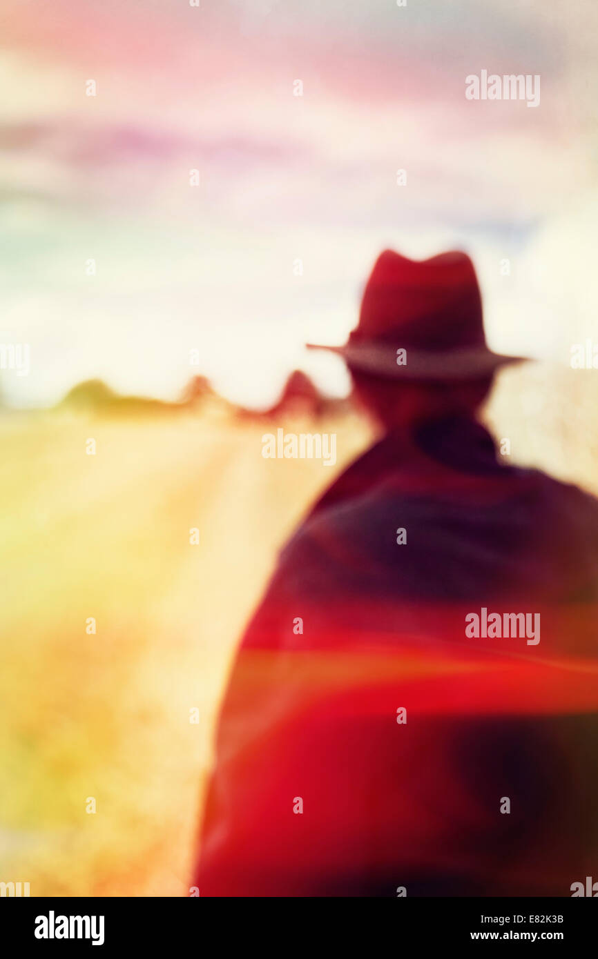 Teenage boy with hat and coat on stubble field Stock Photo - Alamy