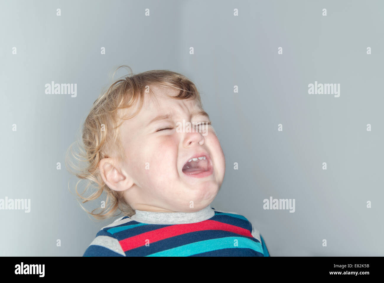 Portrait of a crying baby boy Stock Photo - Alamy