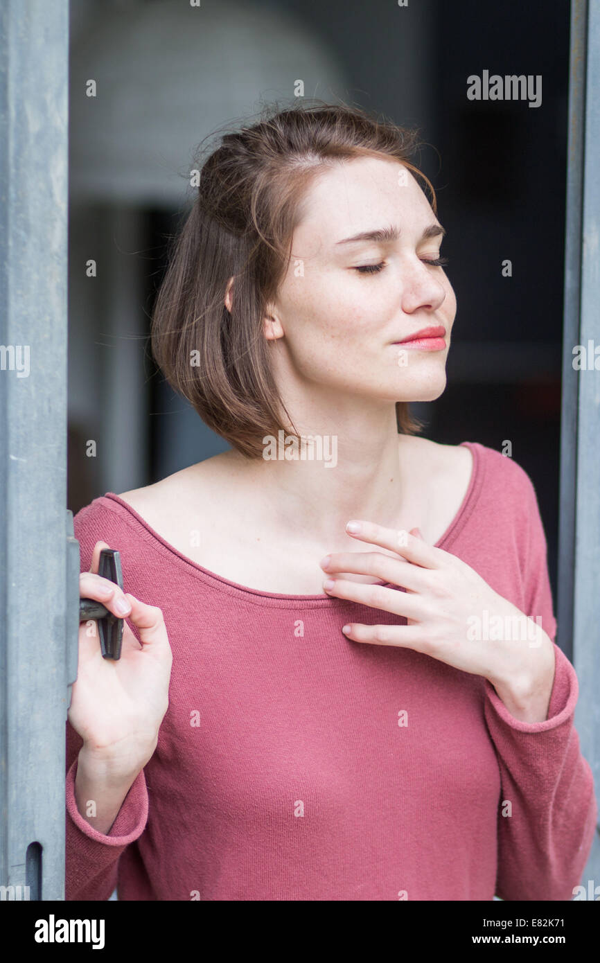 Woman opening window Stock Photo - Alamy