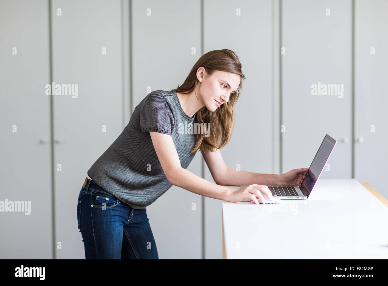 Woman working up Stock Photo - Alamy