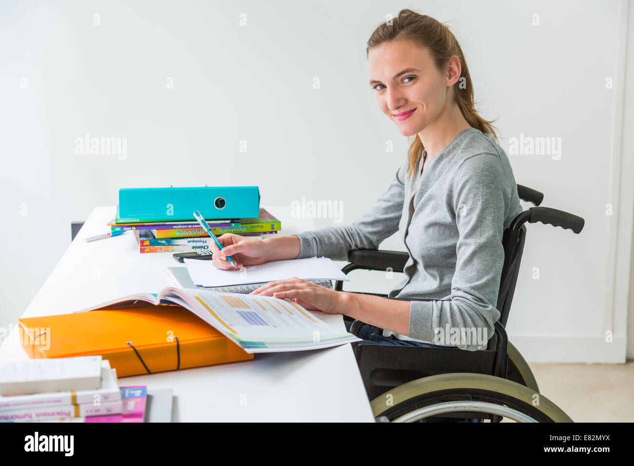 Woman in wheelchair working Stock Photo - Alamy