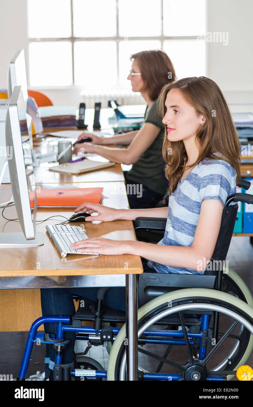 Woman in wheelchair working Stock Photo - Alamy