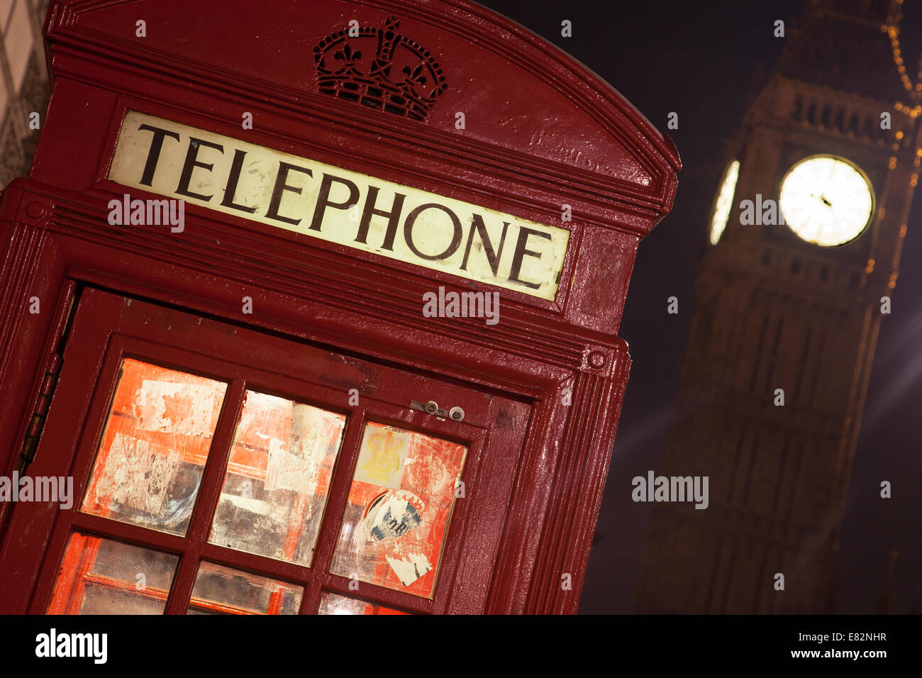 London telephone box and Big Ben in background at night. With light ...