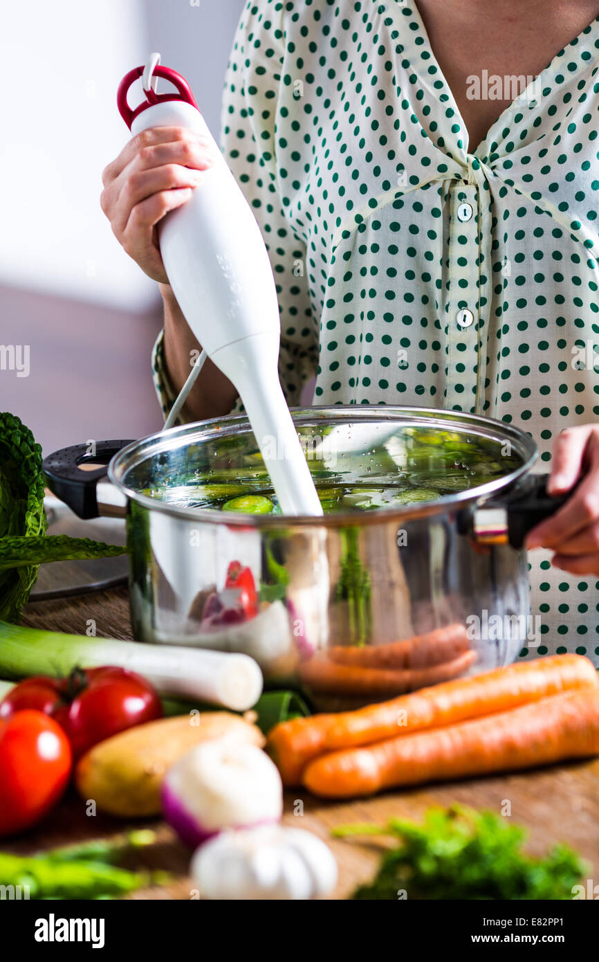 Woman making soup Stock Photo - Alamy