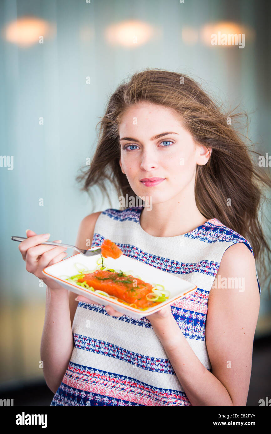 Woman eating fish hi-res stock photography and images - Alamy