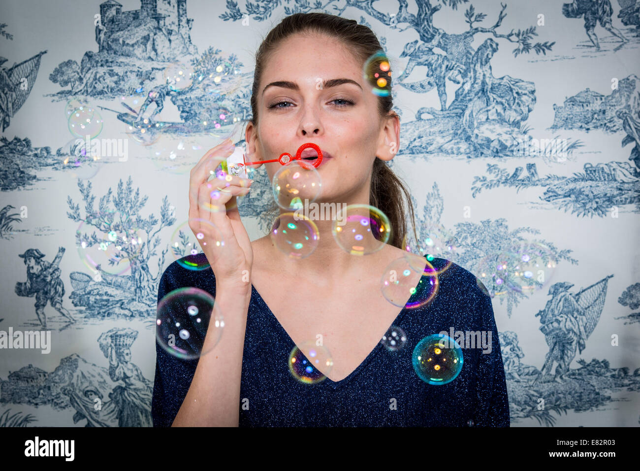 Woman making soap bubbles Stock Photo - Alamy
