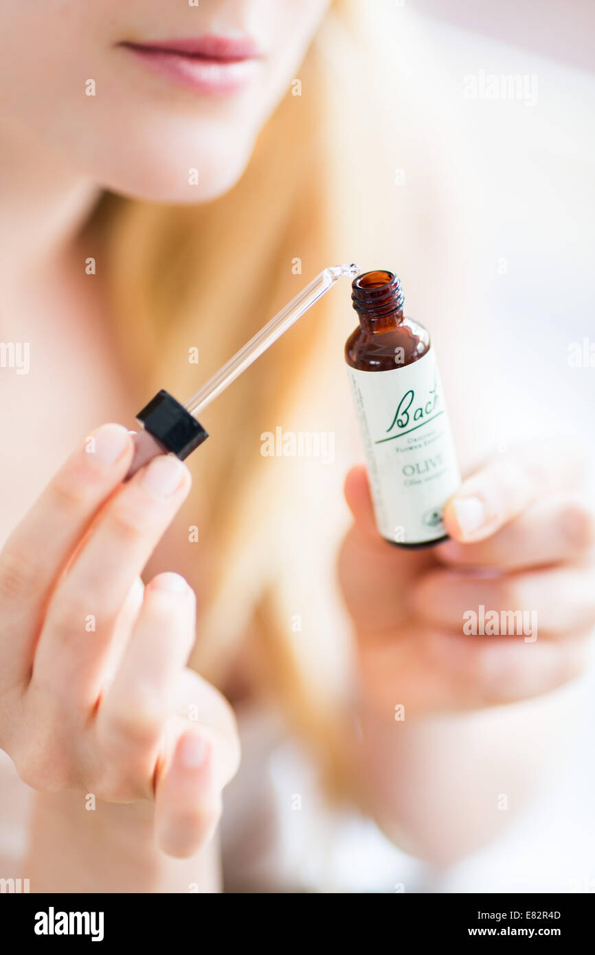 Woman using a Bach remedy (liquid flower extract Stock Photo - Alamy